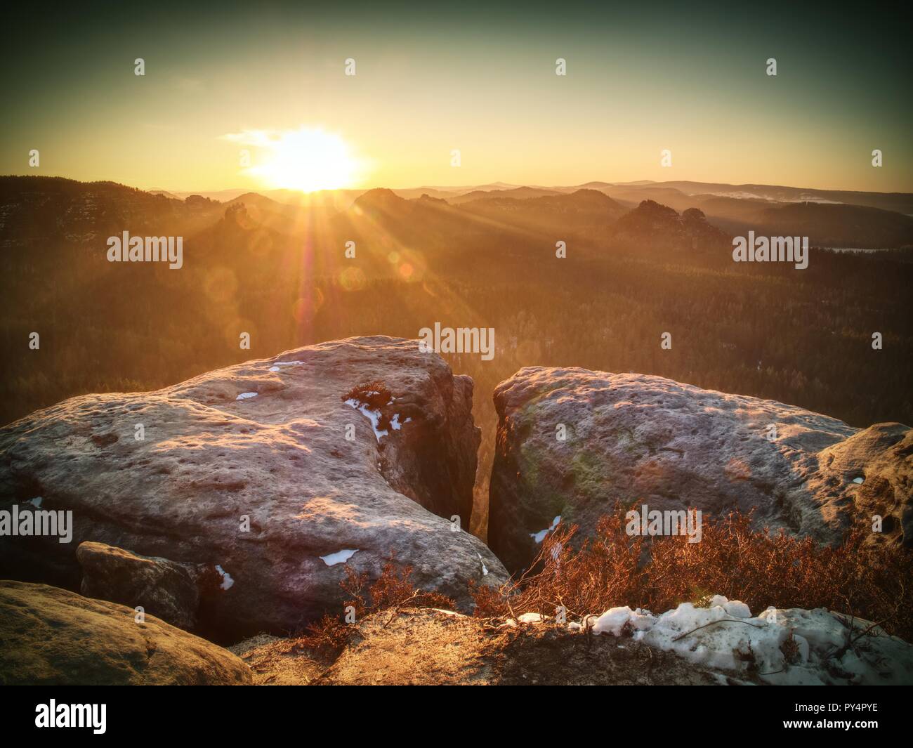 Spring melting of latest snow on exposed sandstone rocks. Hot spring ...