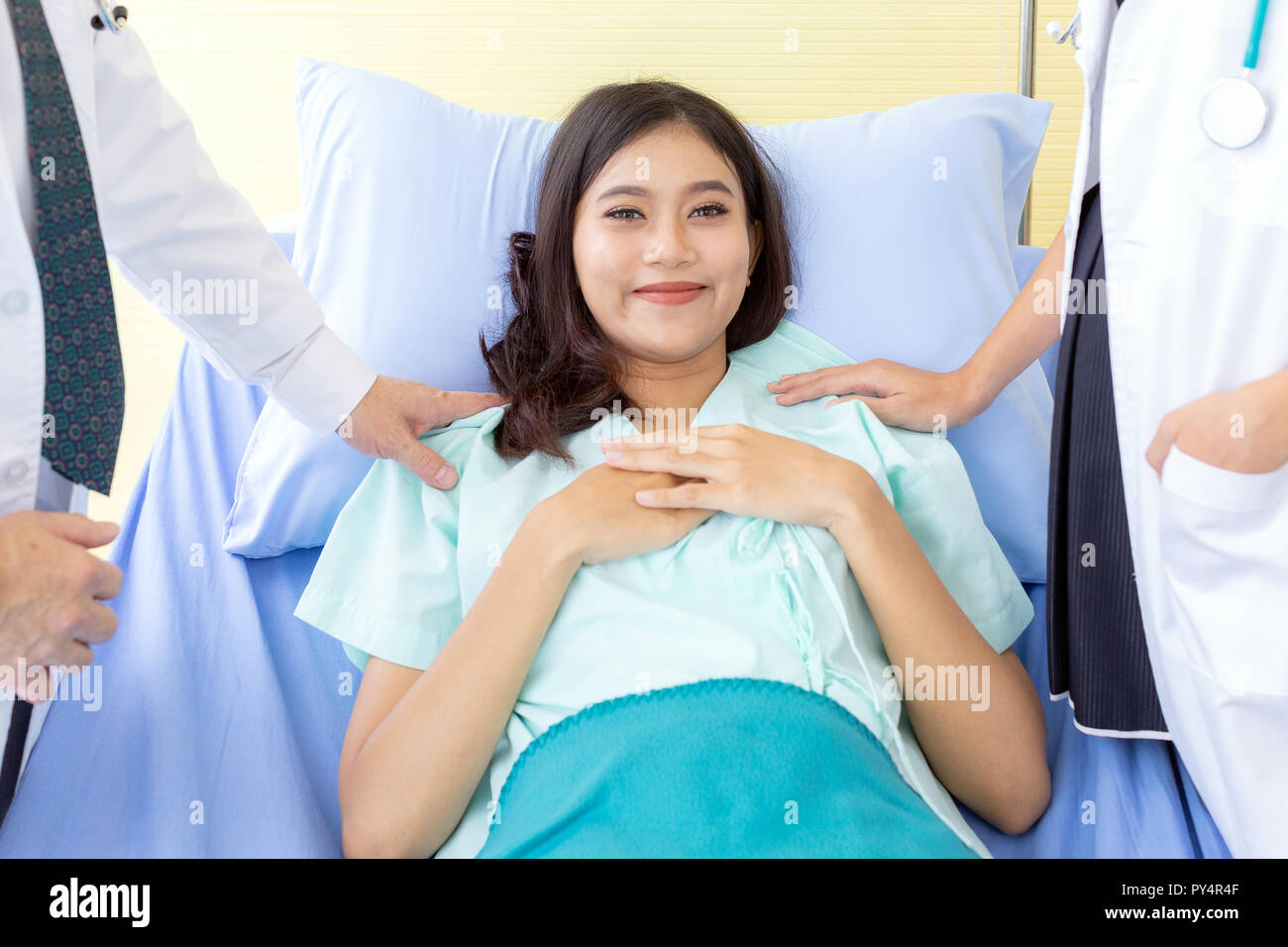 Portrait of female patient Relaxing ans smile in bed of Hospital Ward ...