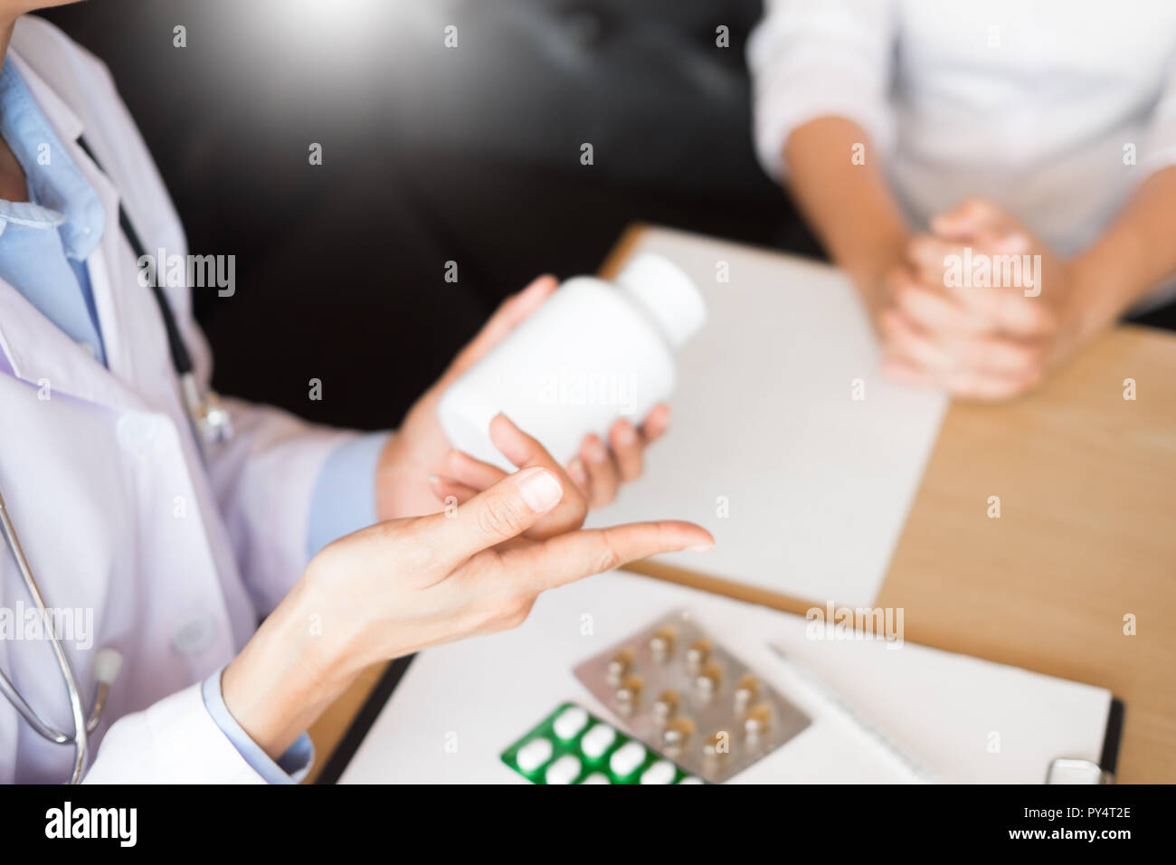 doctor hand holding tablet of drug and explain to patient in hospital ...