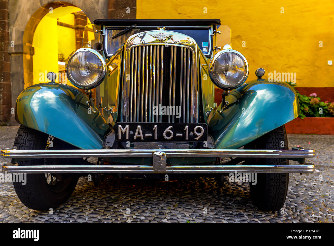 An antique car in a colorful yellow fort in Funchal - Maderia ...