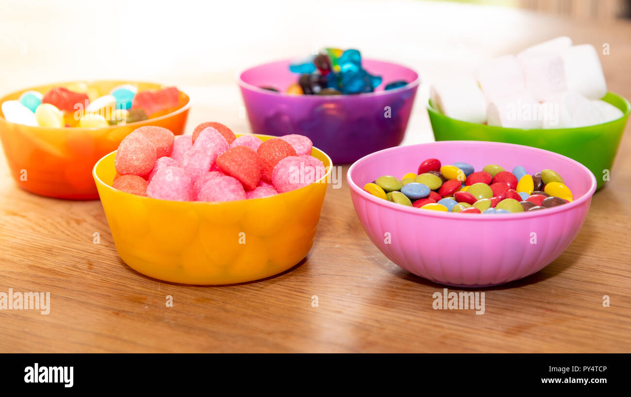 Full of candy in plastic bowls Stock Photo - Alamy