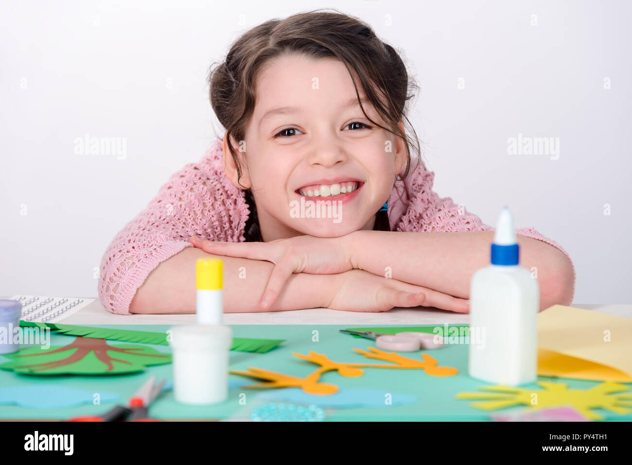 Happy girl and colored paper Stock Photo - Alamy