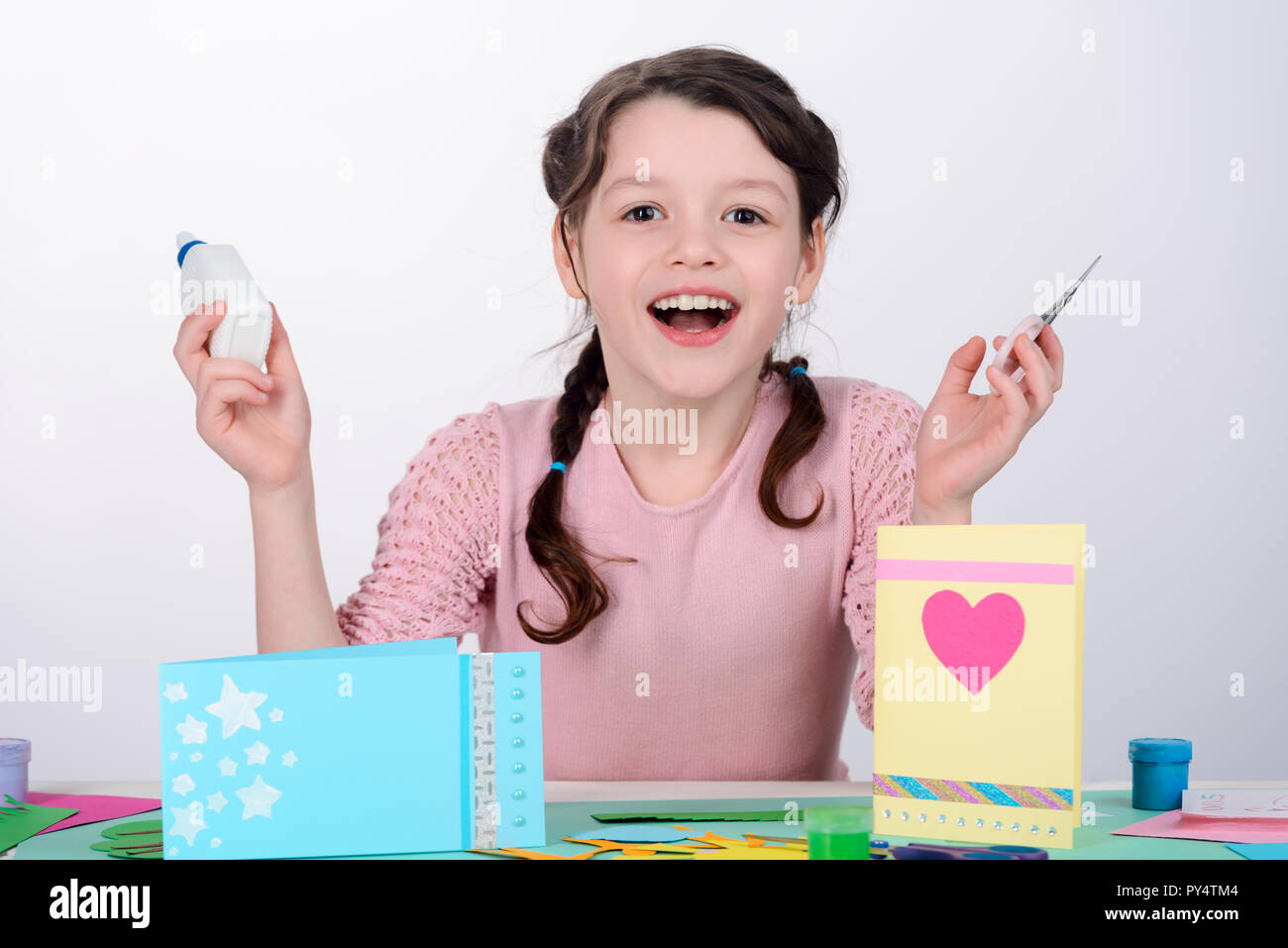 Girl holding glue and scissors Stock Photo - Alamy