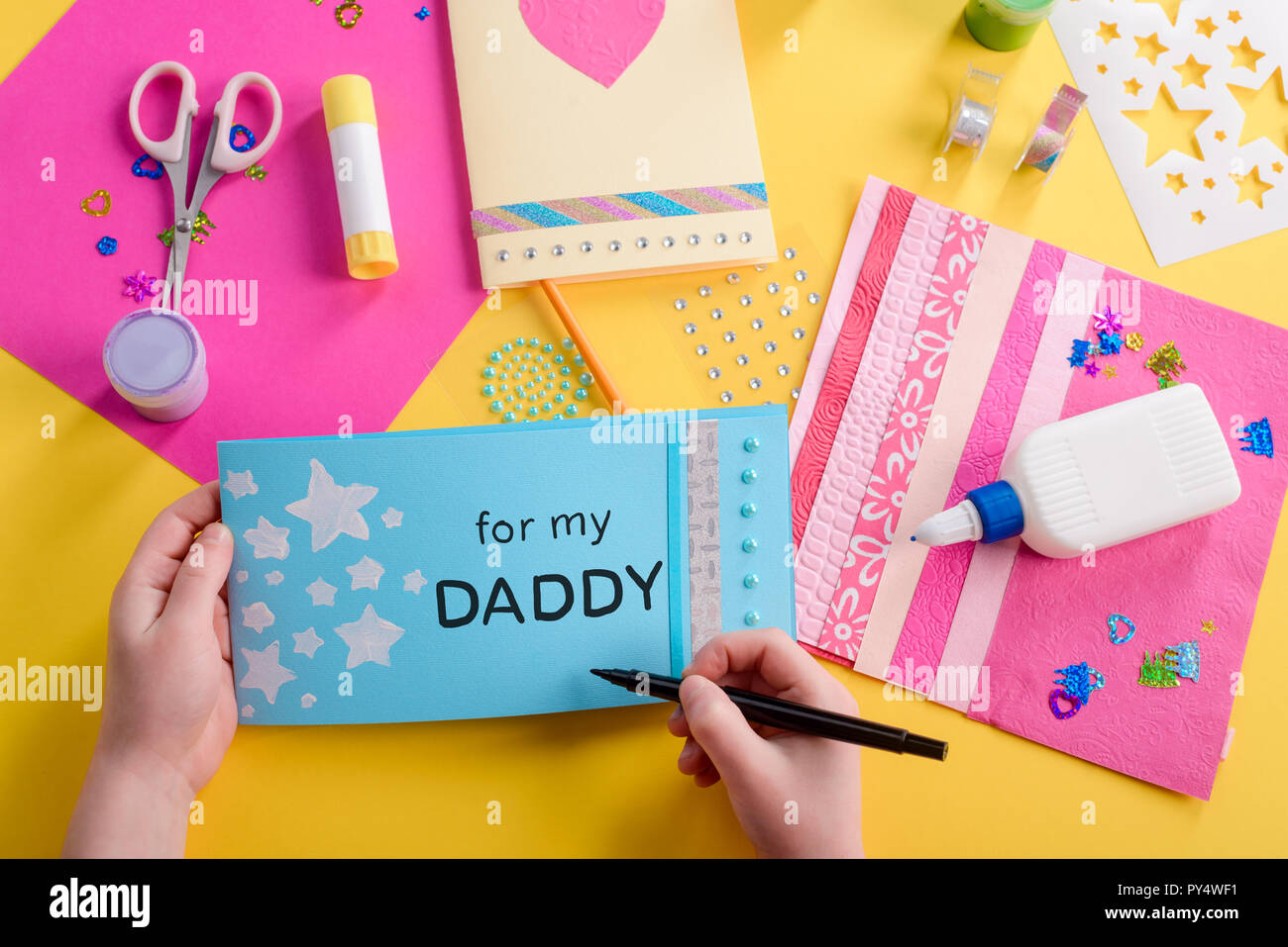 Girl signs a card Stock Photo - Alamy