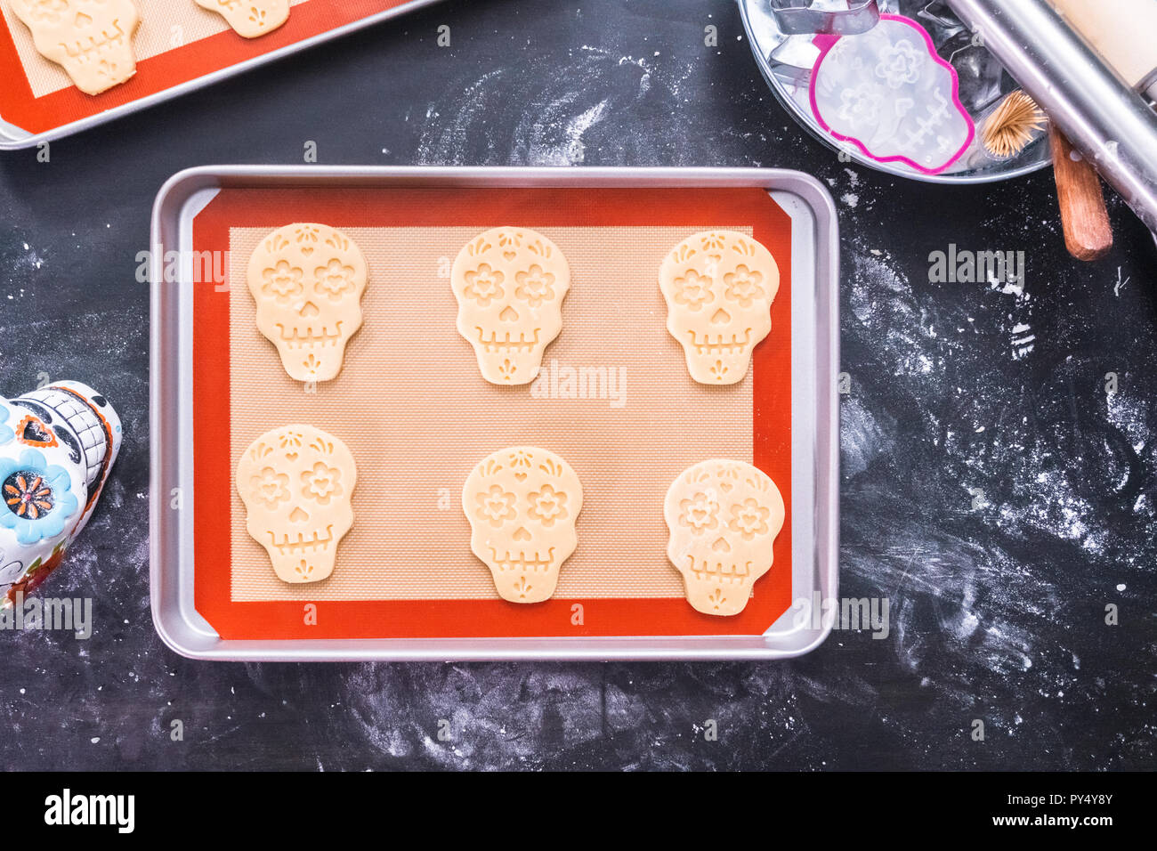 Unbaked sugar skull cookies on baking sheet for Dia de los Muertos ...