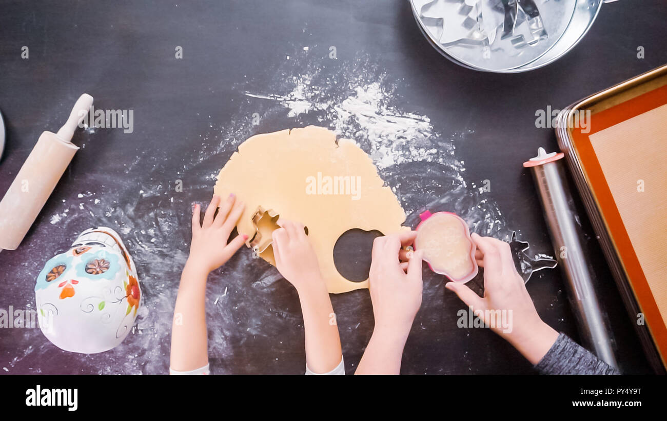 Flat lay. Mother and daughter baking sugar skull cookies for Dia de los Muertos holiday Stock ...