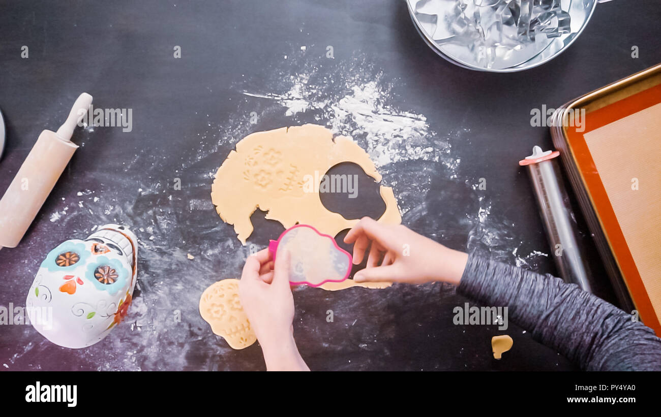 Flat lay. Woman baking sugar skull cookies for Dia de los Muertos ...