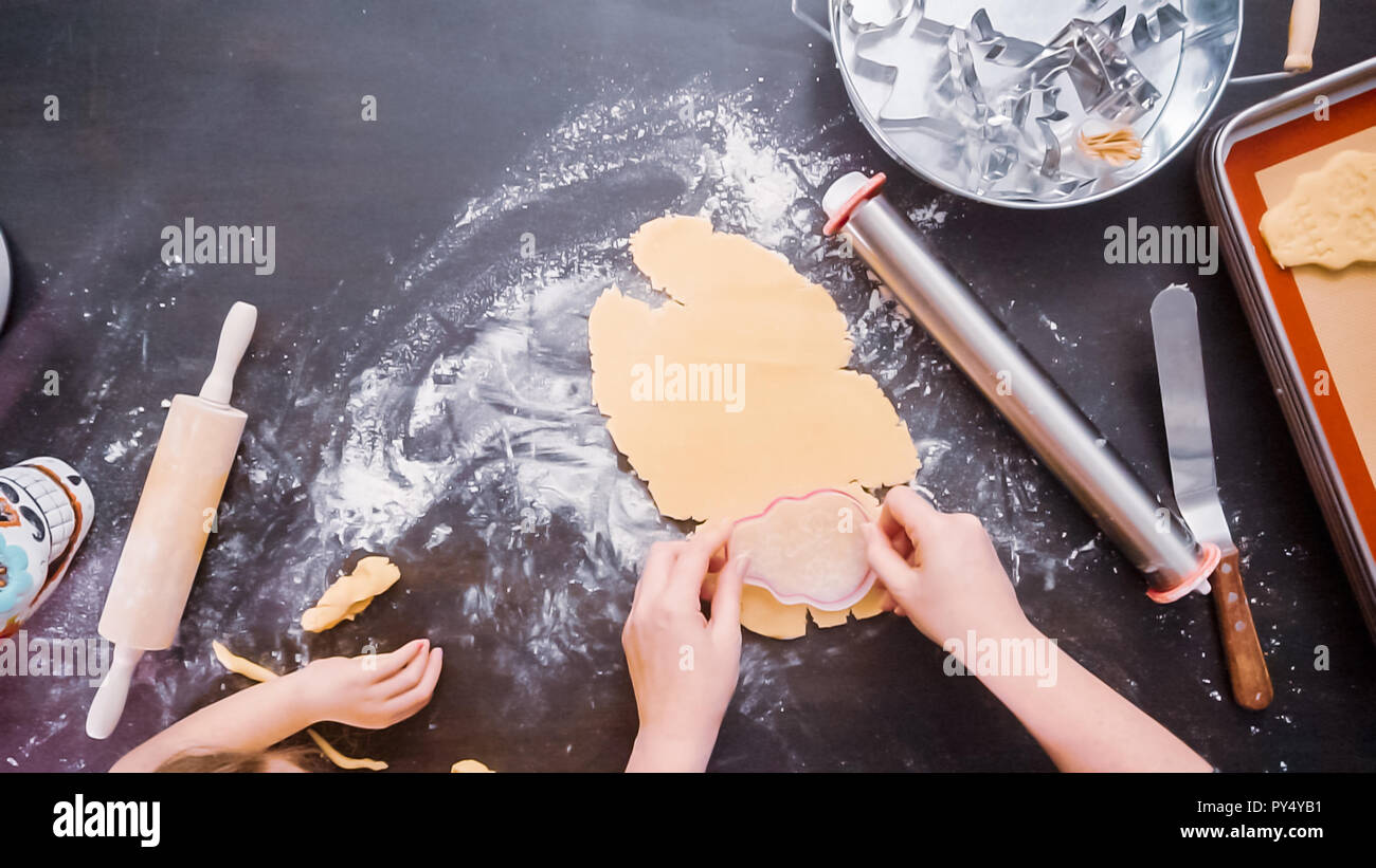 Flat lay. Mother and daughter baking sugar skull cookies for Dia de los Muertos holiday Stock ...