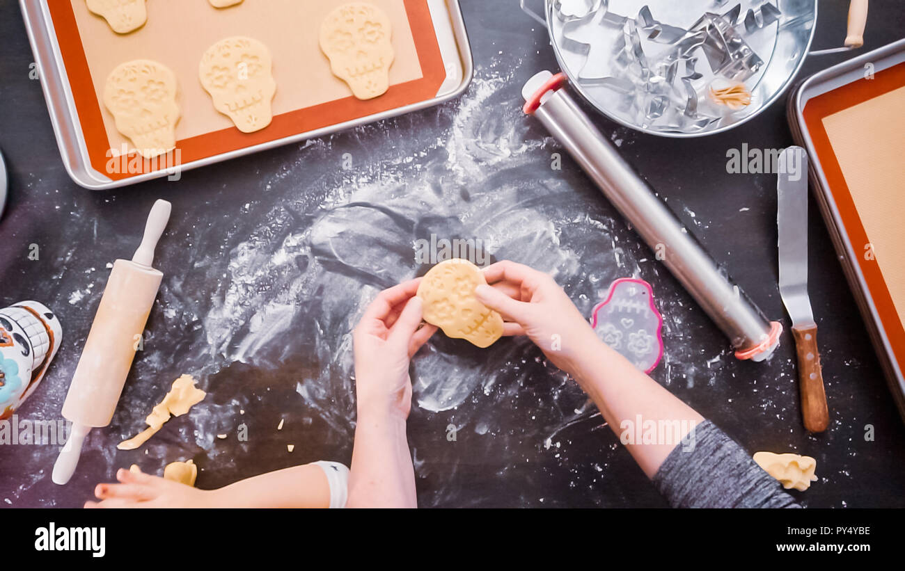 Flat lay. Mother and daughter baking sugar skull cookies for Dia de los Muertos holiday Stock ...