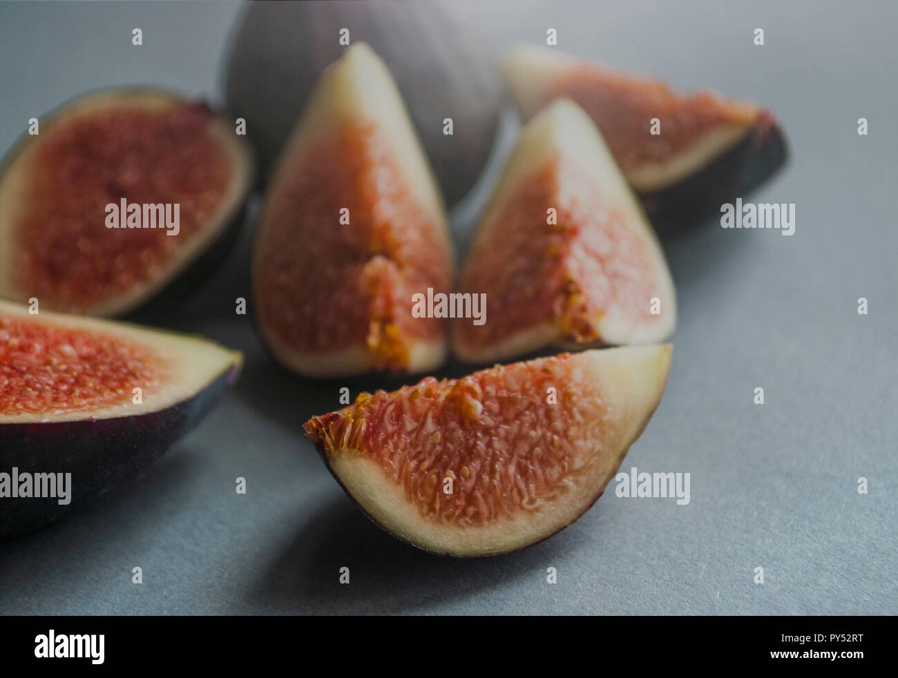 Freshly picked sweet ripe and cut figs on grey background Stock Photo ...