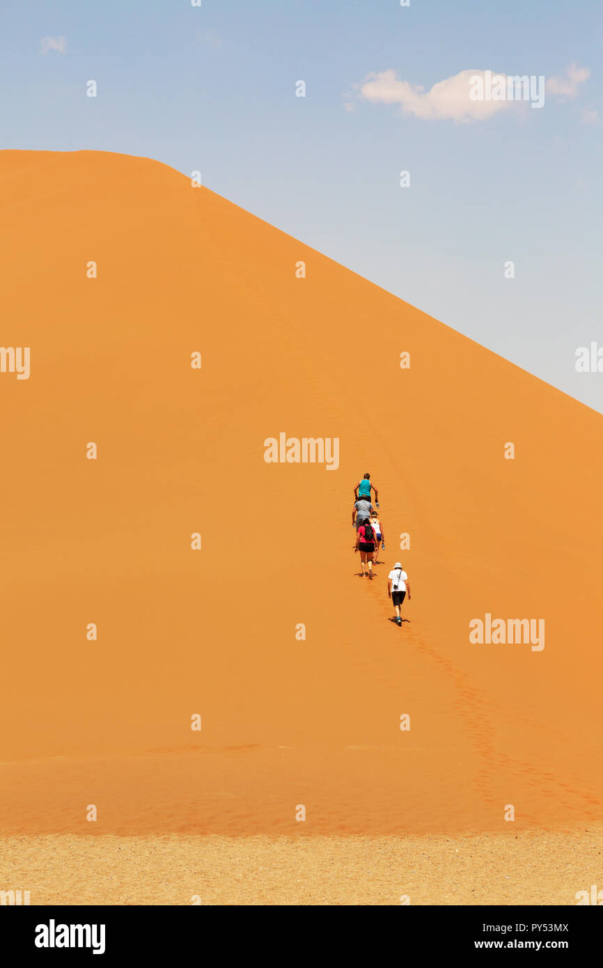 People climbing sand dunes, Sossusvlei, Namib Desert, Namibia Africa ...