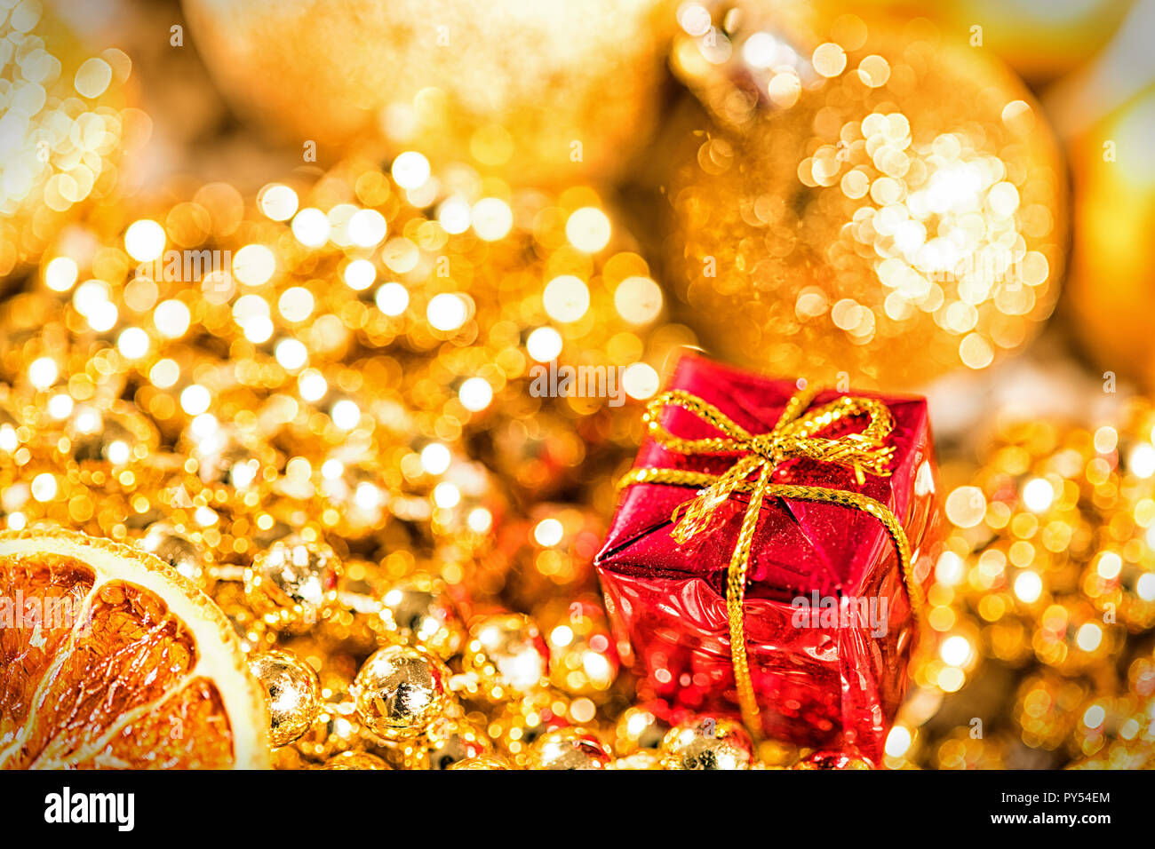 red christmas present with golden necklace and christmas tree balls ...