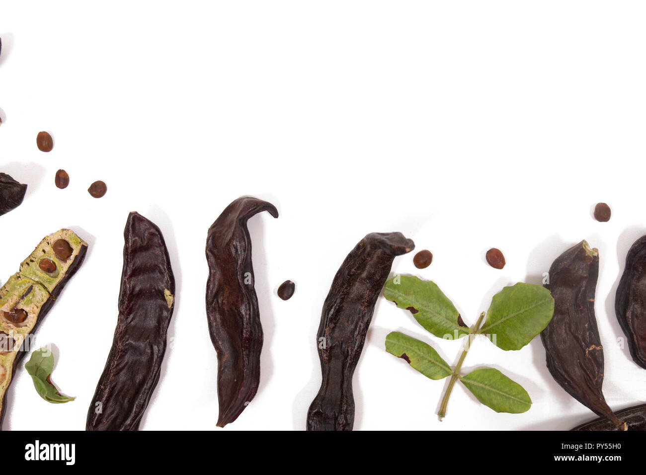 carob fruits assortment isolated over a white background Stock Photo ...