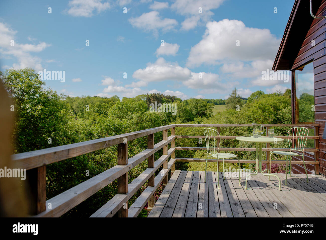 A wide view shot of a rural landscape from a balcony, a bright blue sky ...