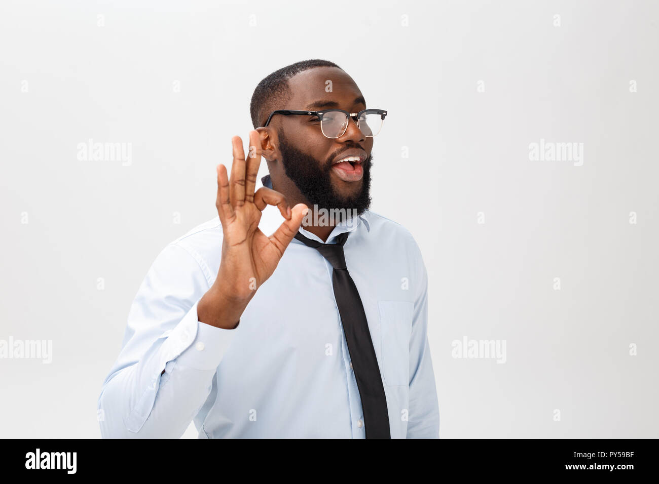 Young black businessman having happy look, smiling, gesturing, showing ...