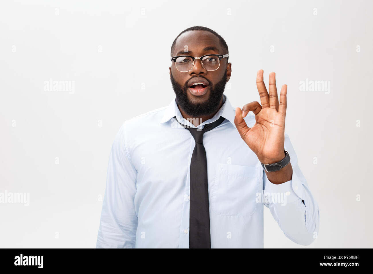 Young black businessman having happy look, smiling, gesturing, showing ...