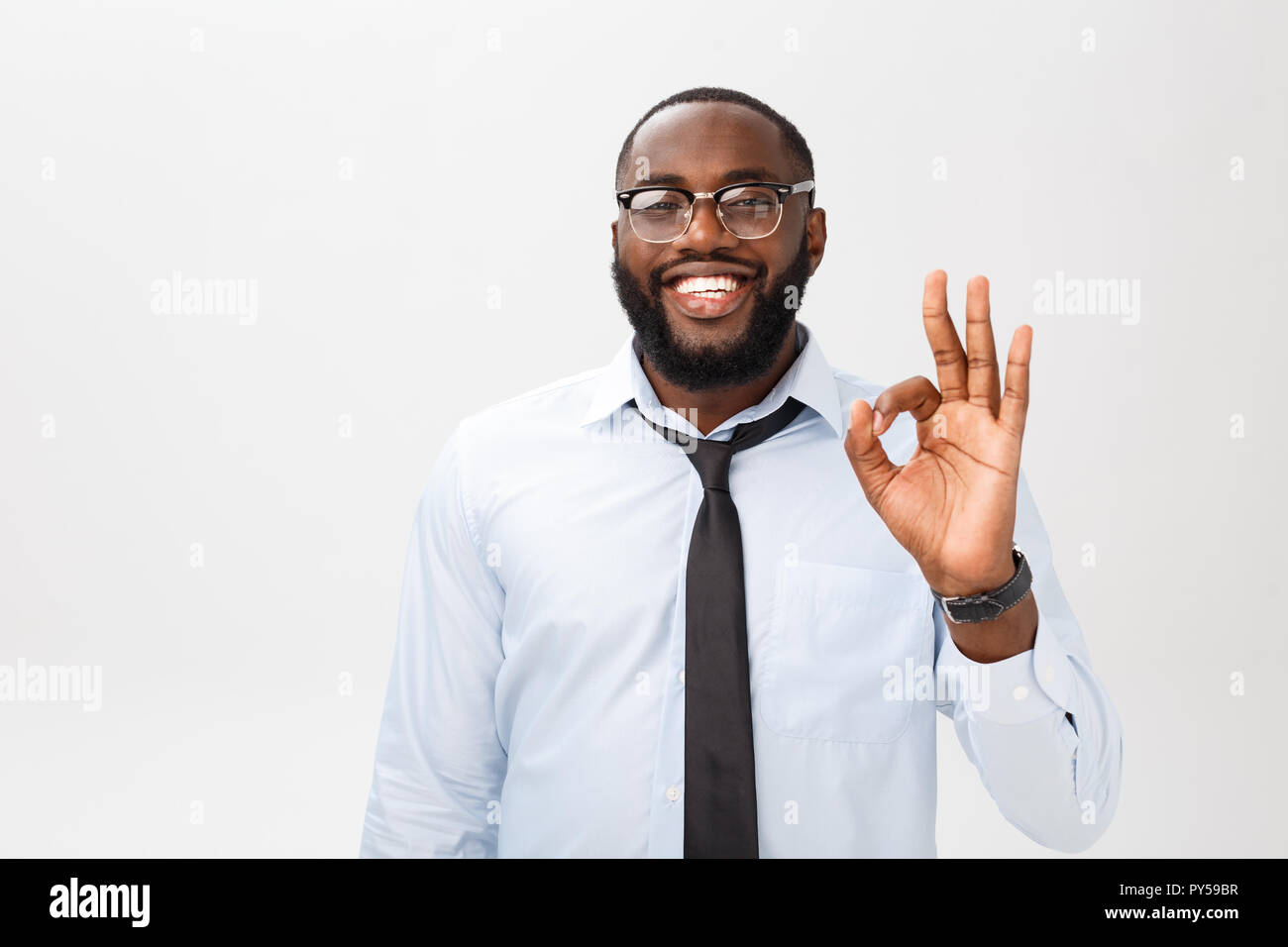 Portrait of african american business man smiling and showing okay sign ... Portrait of african american business man smiling and showing okay sign ...