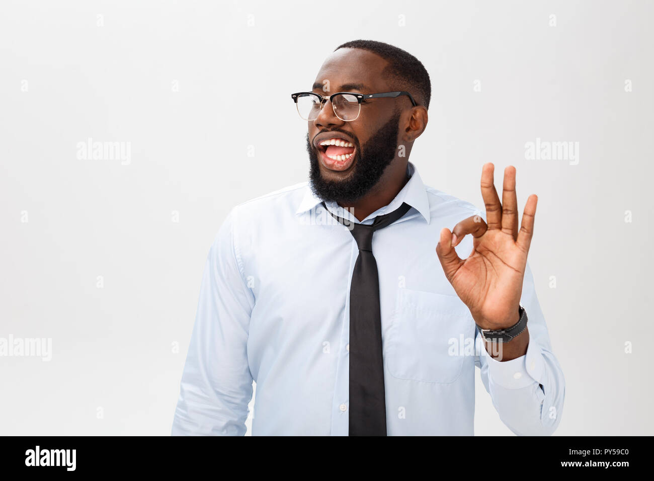Portrait of african american business man smiling and showing okay sign ...