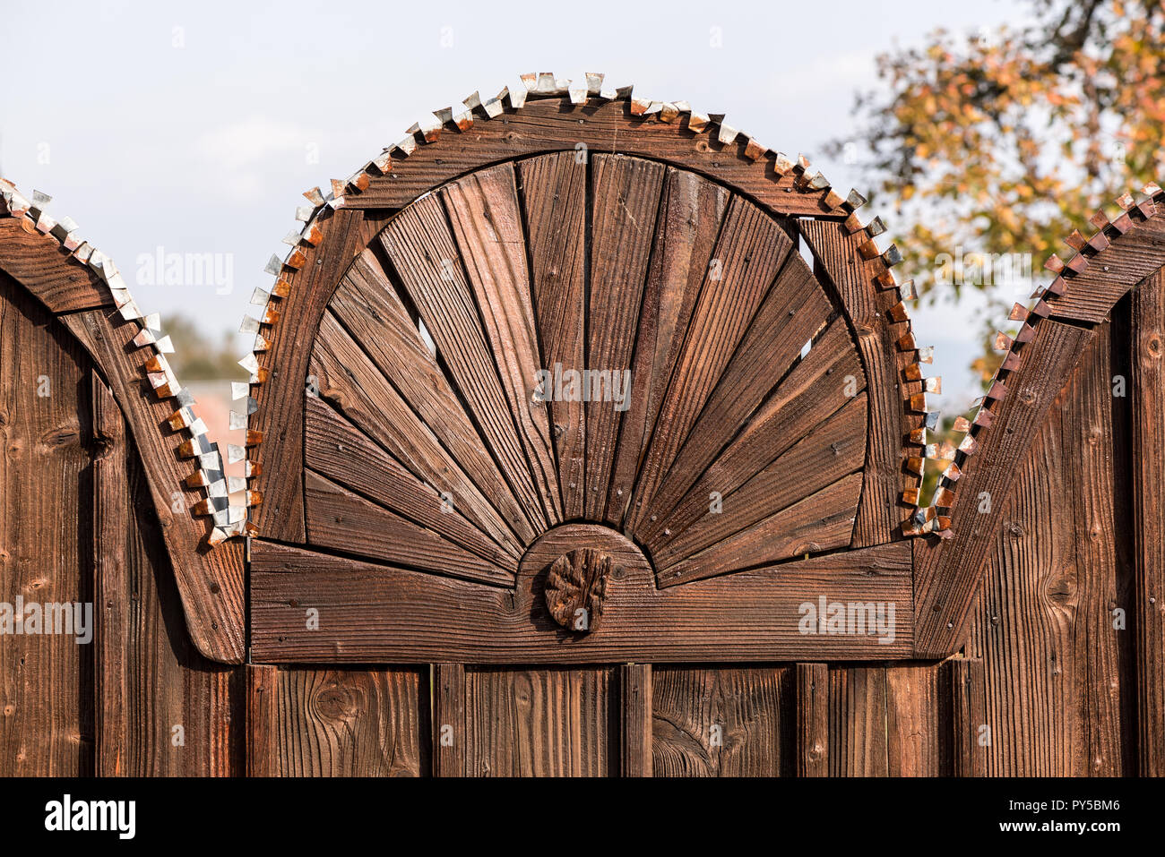 Traditional hand carved symbolic old gate fragment. Bird and sun motifs ...