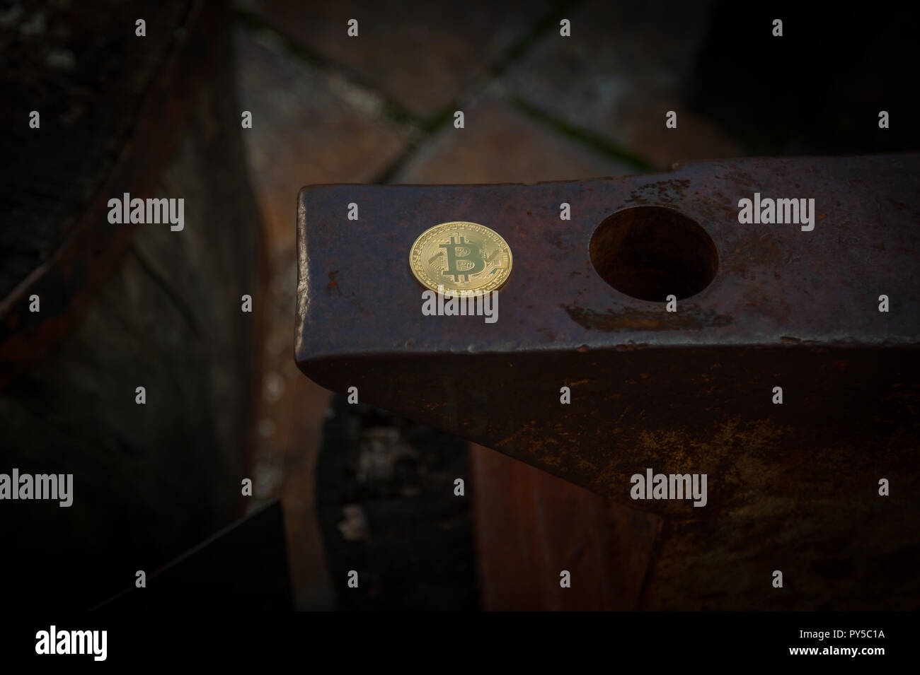 Bitcoin on anvil mine forge Stock Photo - Alamy