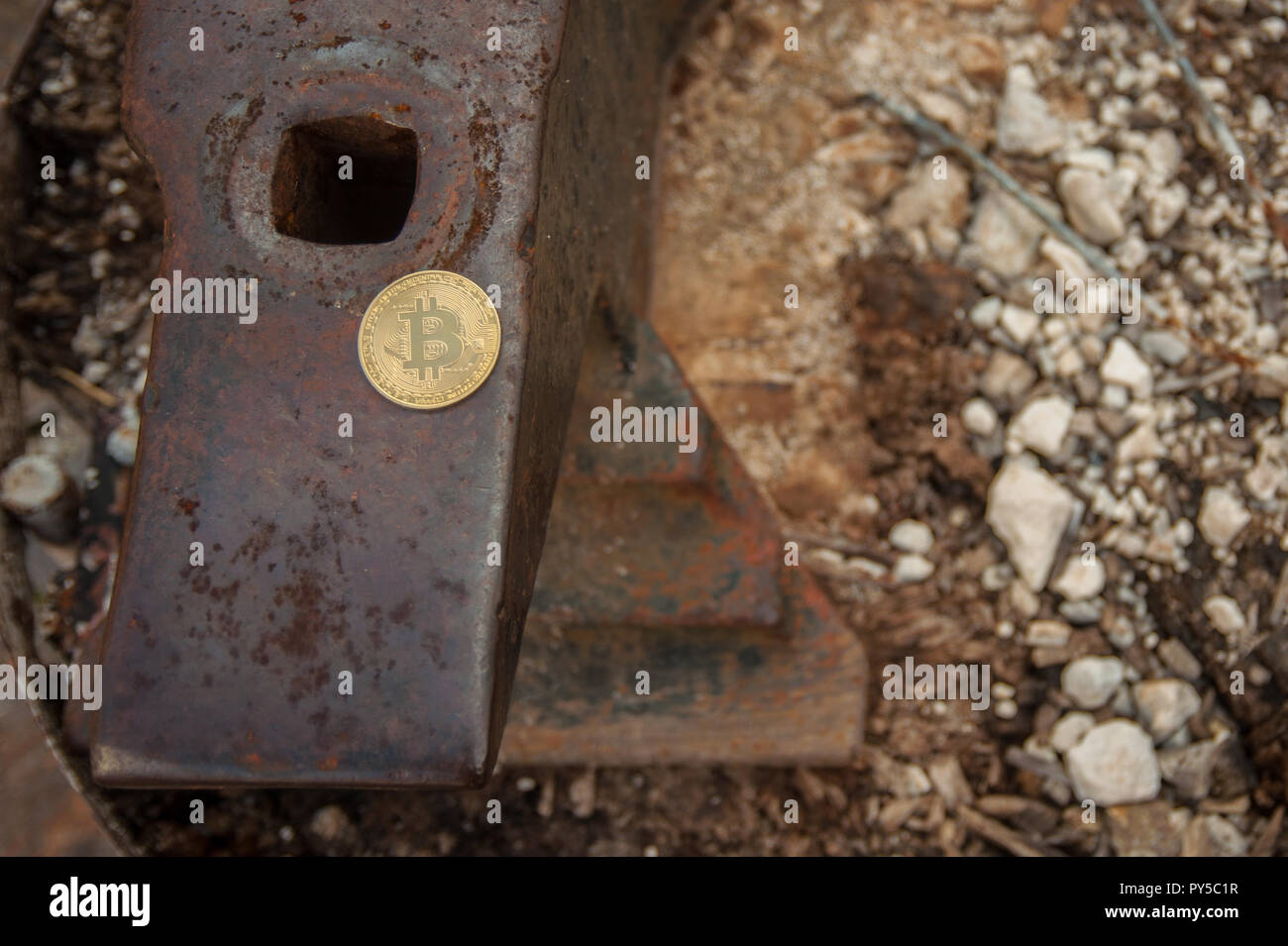 Bitcoin on anvil mine forge Stock Photo - Alamy