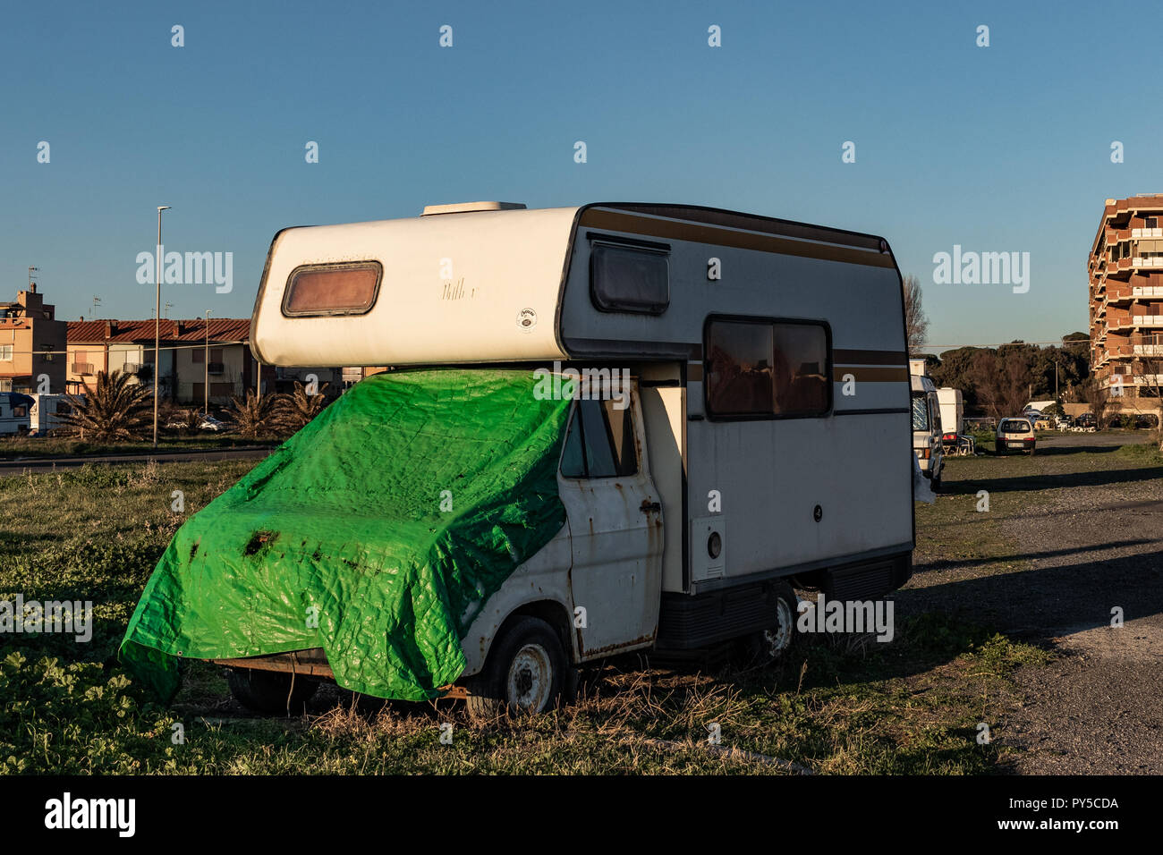 Old gipsy trailer left to rust. Outlaw lifestyle, Italian city Stock ...