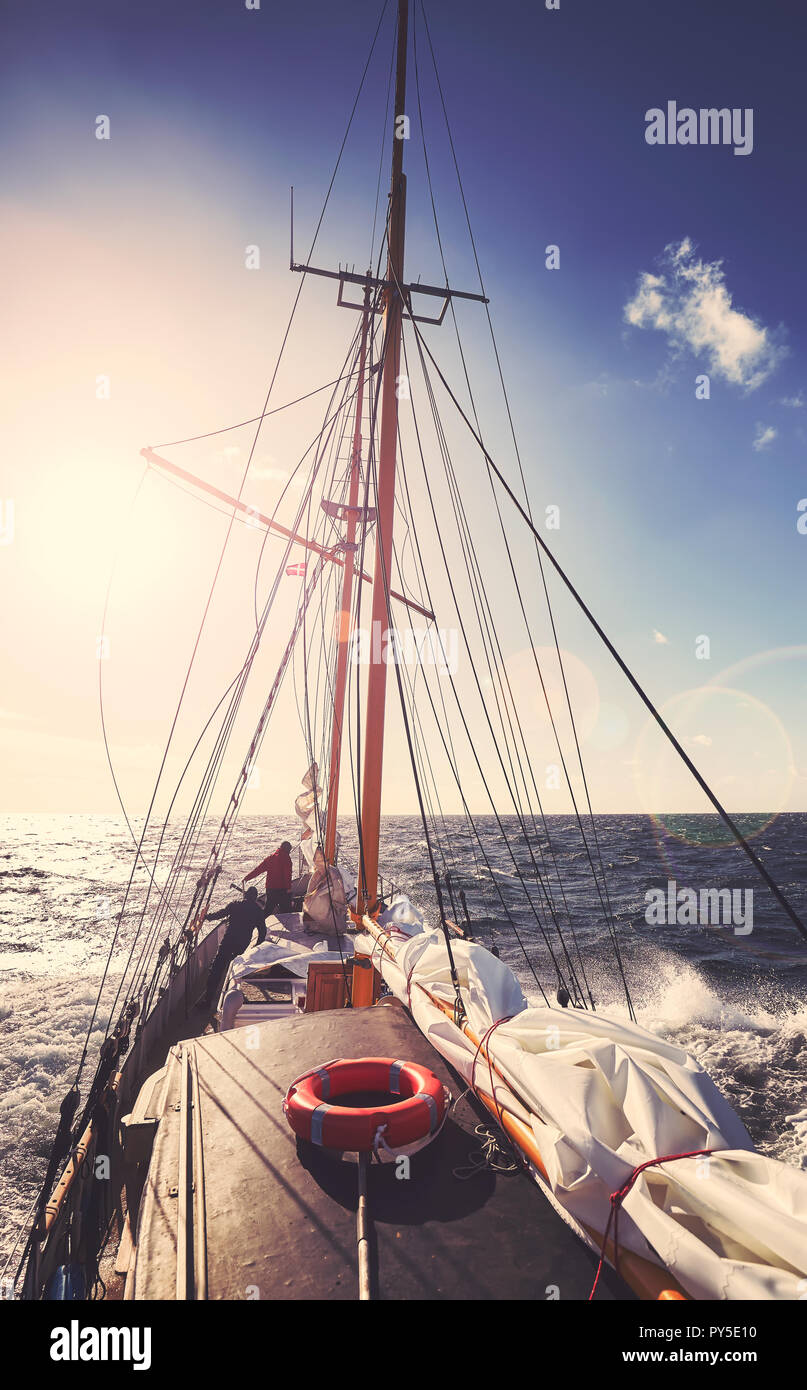 Old sailing ship at sunset with lens flare, color toned picture Stock ...