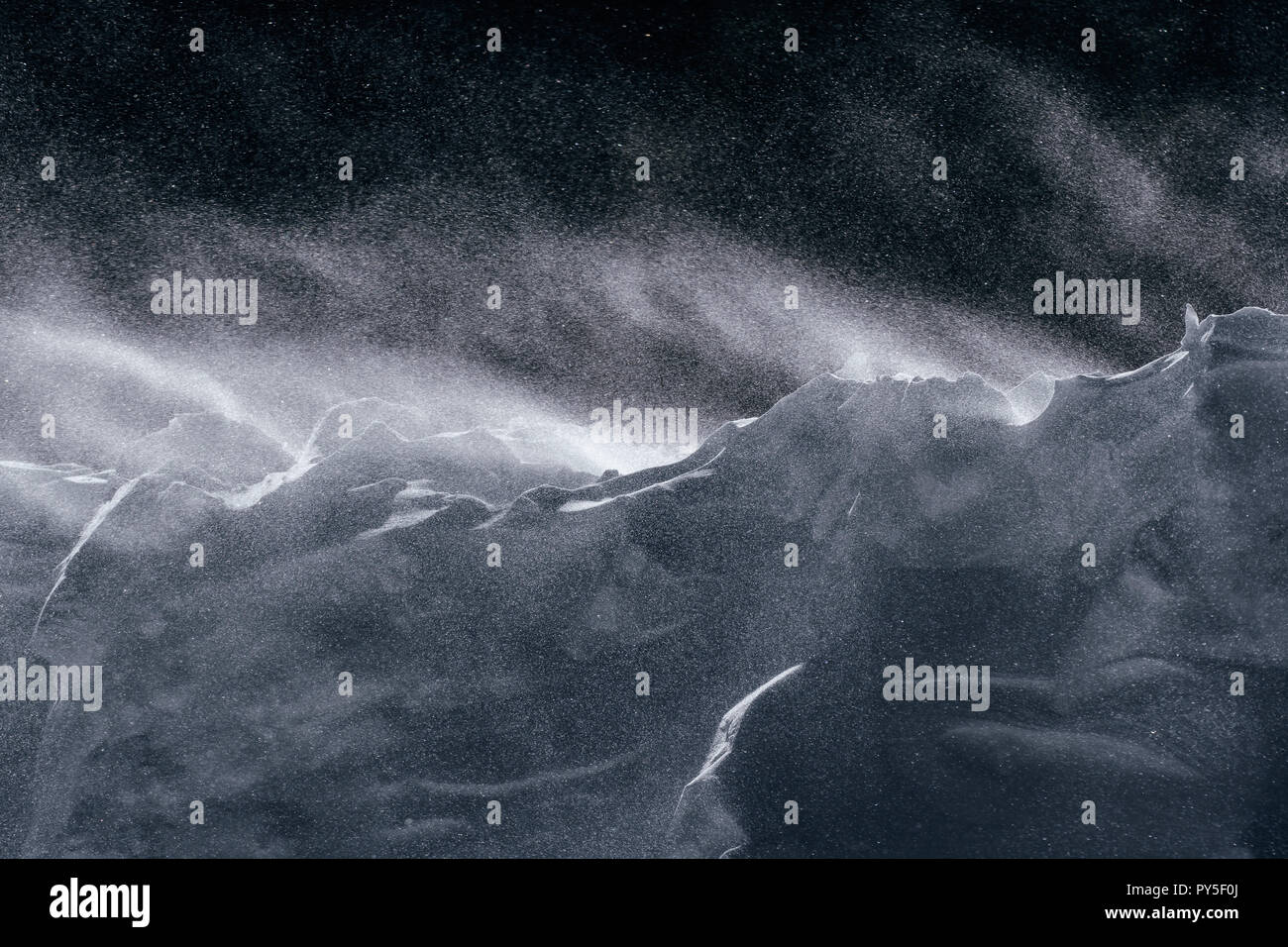 Wind blows fresh snow over an embankment Stock Photo - Alamy