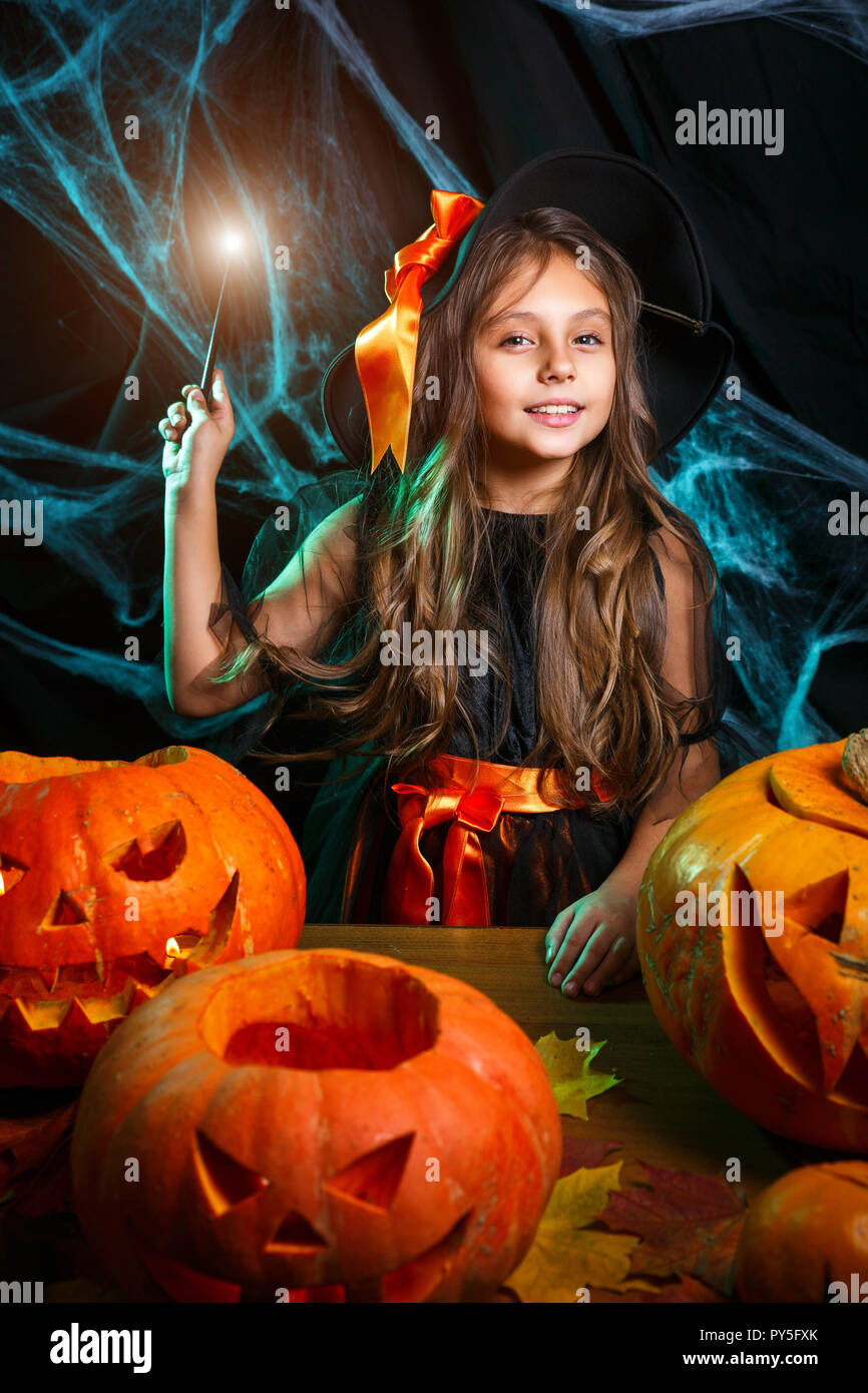 Halloween Witch concept - little witch child enjoy playing with magic ...