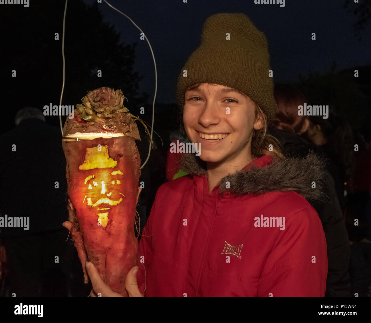 Hinton St George, Somerset, UK - 25 October 2018. A young woman holds a ...