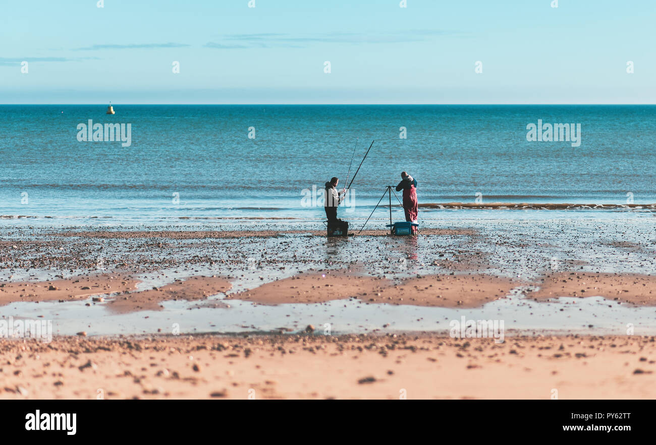 Man catching fish on seaside hi-res stock photography and images - Alamy