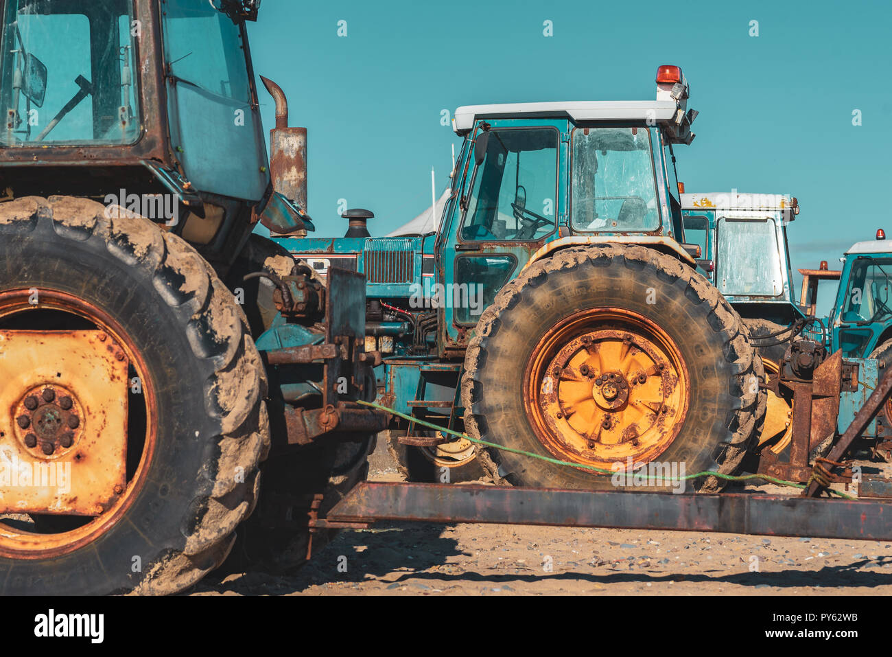 The tractors are lined up, rusty and old looking Stock Photo - Alamy