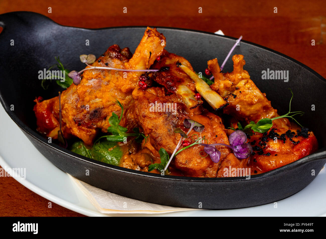 Baked goat with vegetables and sauce Stock Photo - Alamy