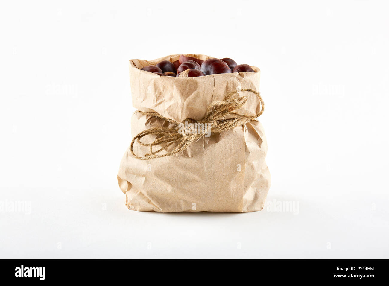 Chestnuts in paper bag on white background Stock Photo - Alamy