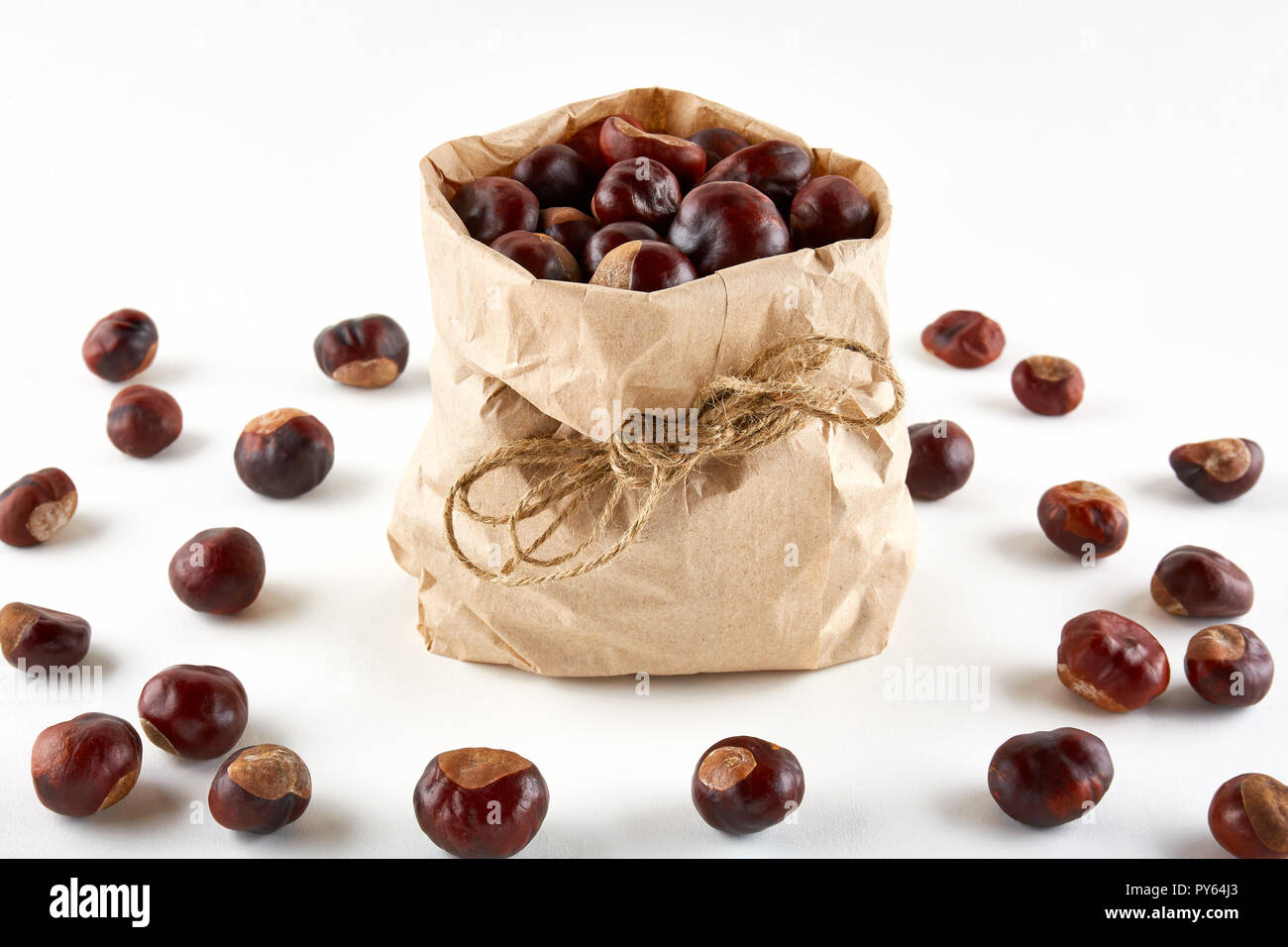 Chestnuts in paper bag on white background Stock Photo - Alamy
