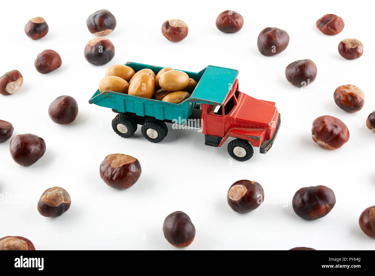 Chestnuts in toy truck on white background Stock Photo - Alamy