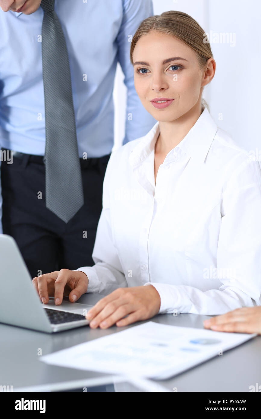 Group of business people using laptop computer in office. Meeting and ...