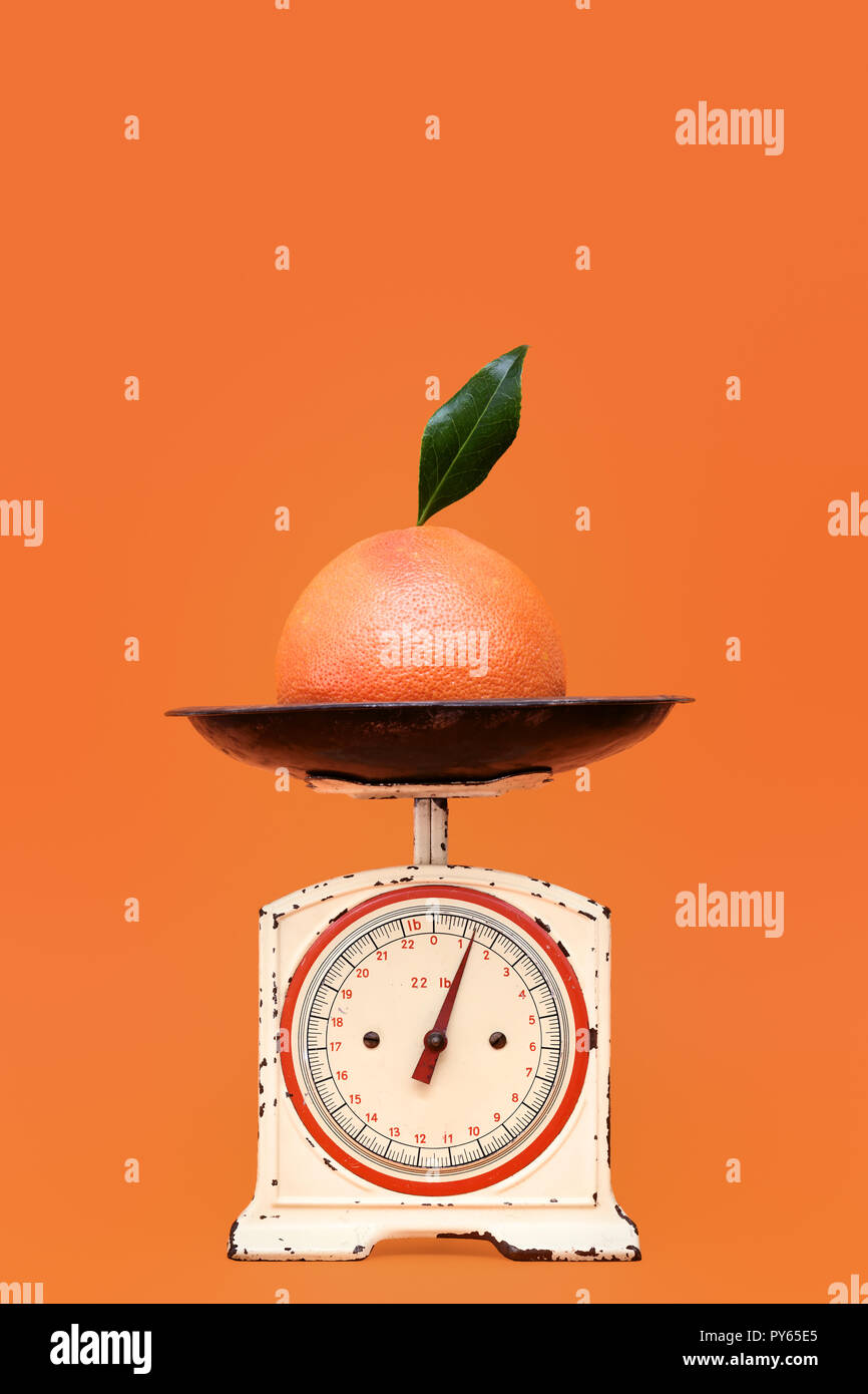 Scale measuring grapefruit weight. This image can also be use for a ...