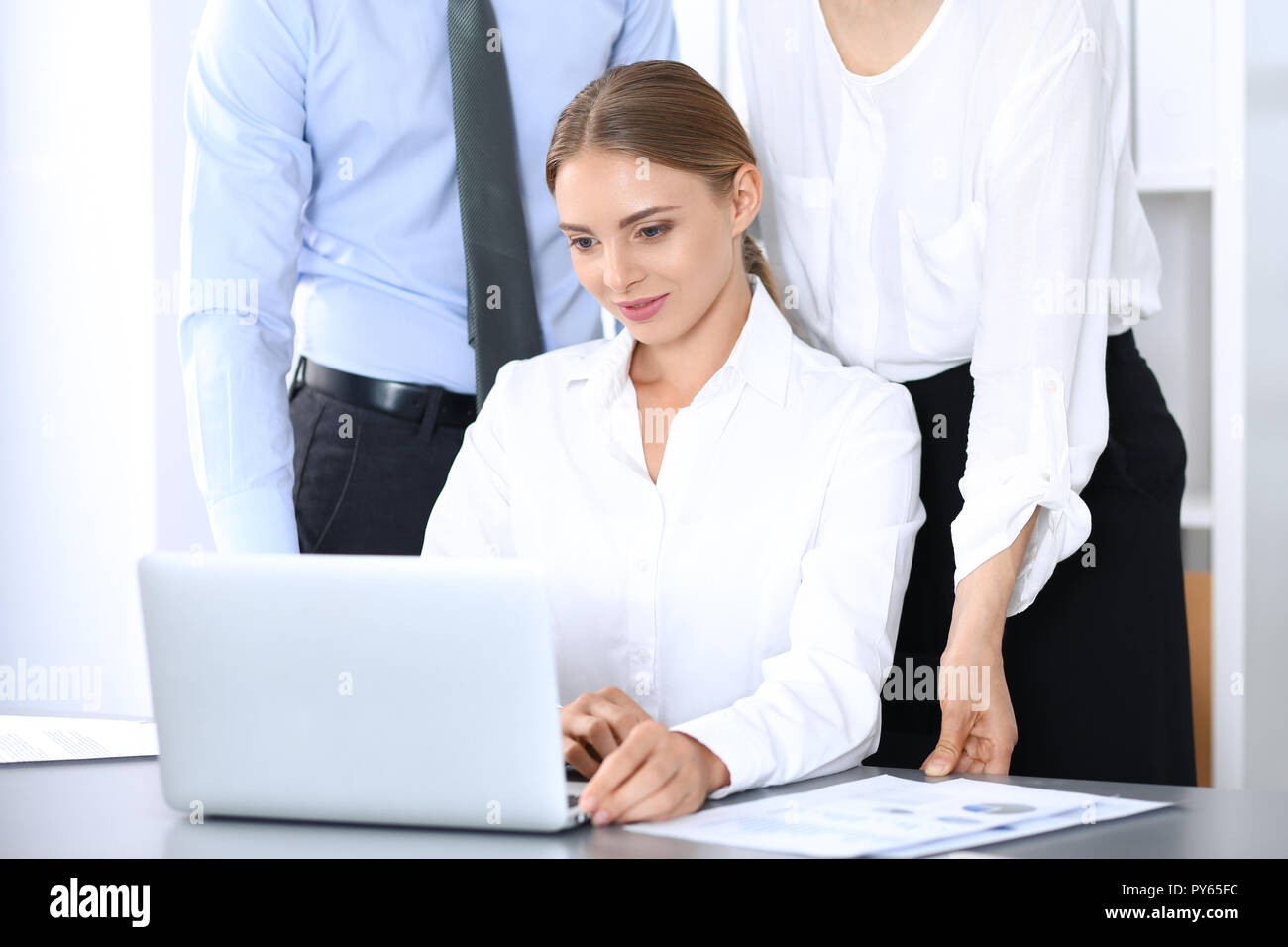 Group of business people using laptop computer in office. Meeting and ...