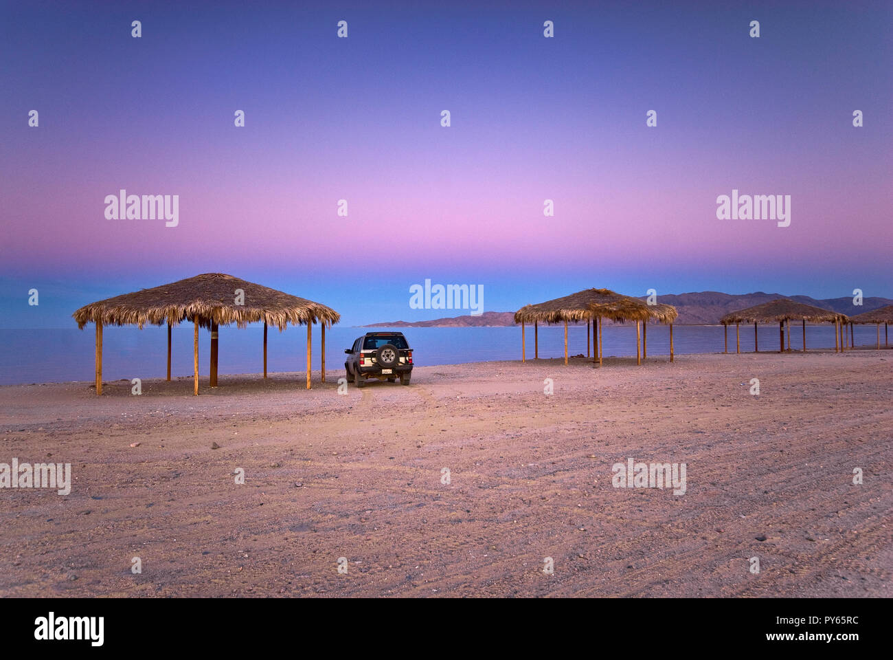 Car at palapa on beach after sunset at Campo Rancho Grande, Baja ...