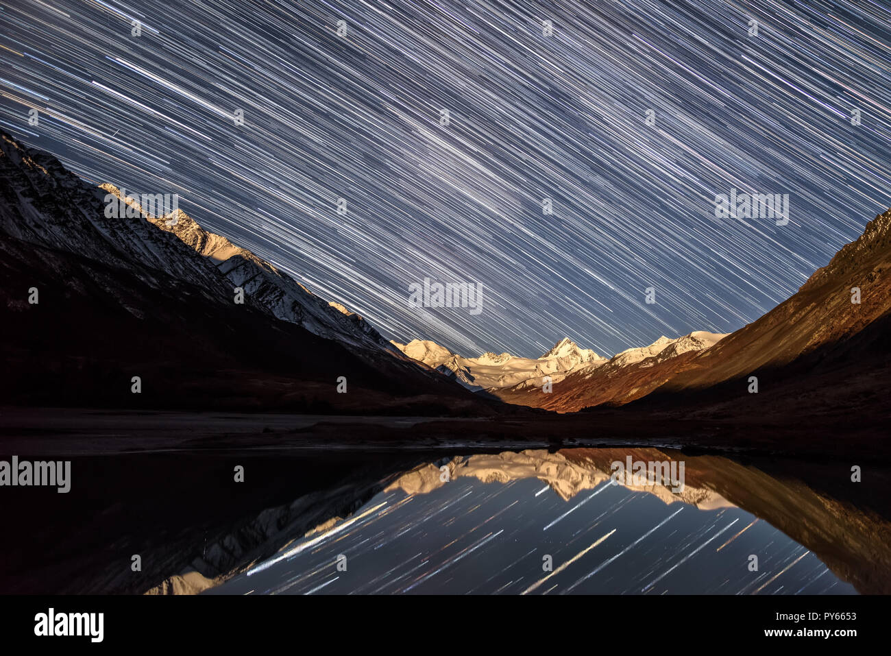 Amazing night view with stars in the form of tracks over the snowy ...