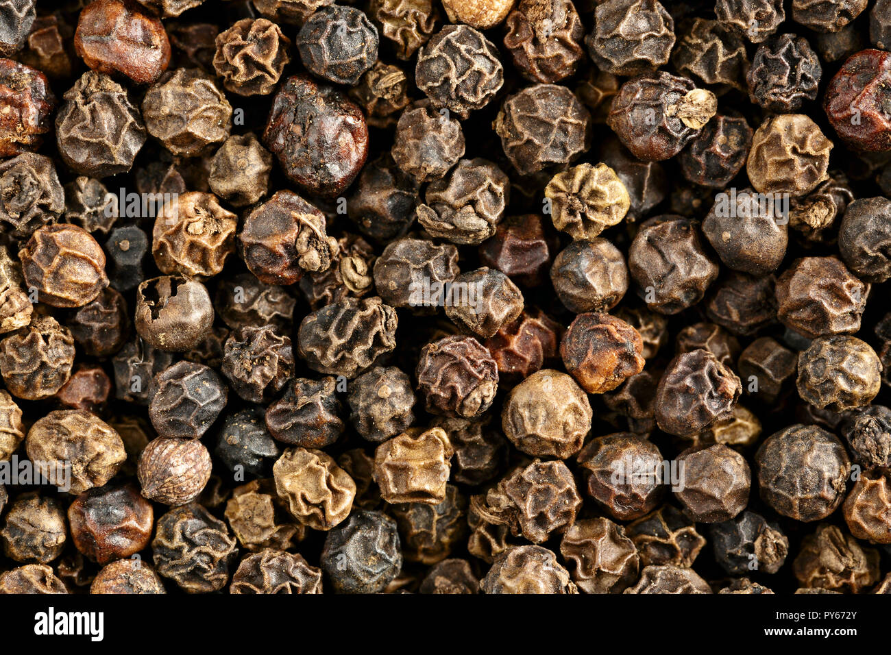 Whole black peppercorns closeup for maximum detail Stock Photo - Alamy