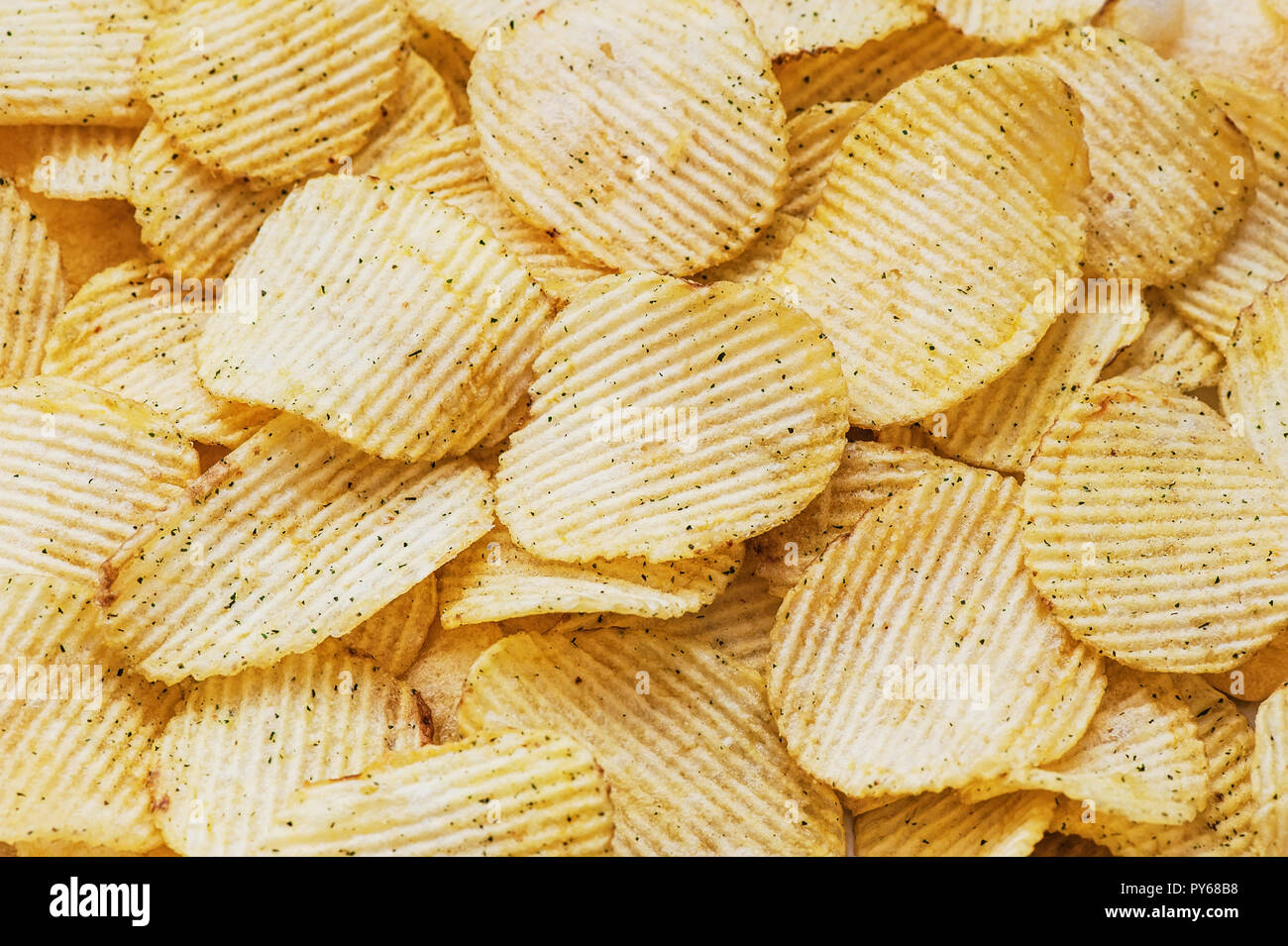 Potato chips corrugated background top view, close-up Stock Photo - Alamy