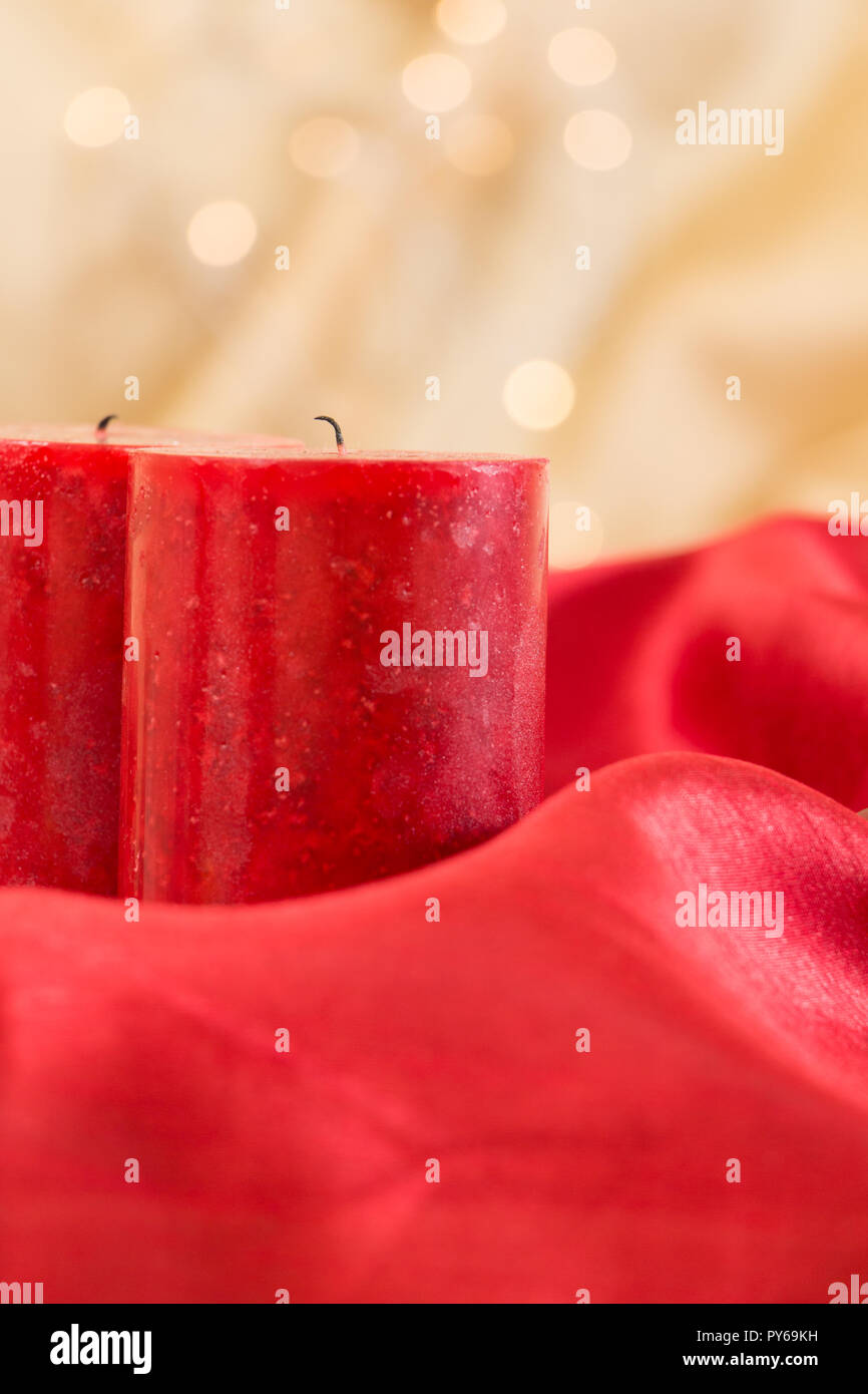 Used red candles with burnt wick, on red wavy fabric and golden ...