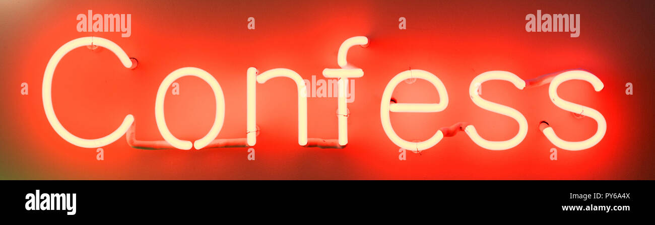 Neon sign - Shining over a white wall - Confess Stock Photo - Alamy