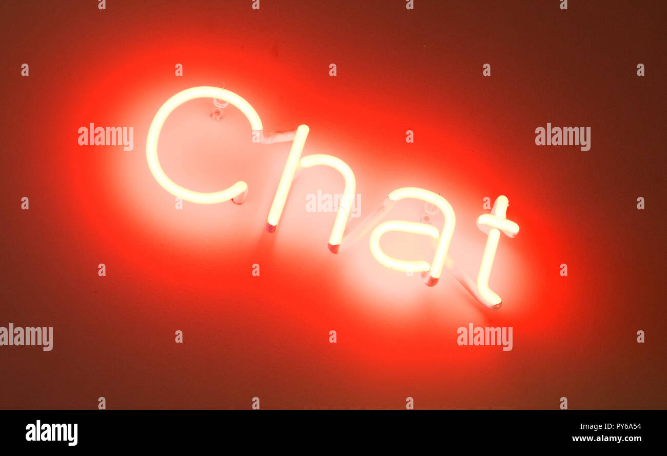 Neon sign - Shining over a white wall - Chat Stock Photo - Alamy