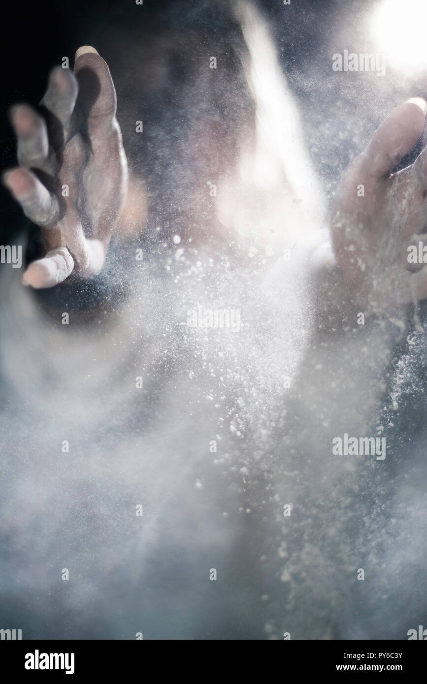 Young woman clapping dust in her hands Stock Photo - Alamy