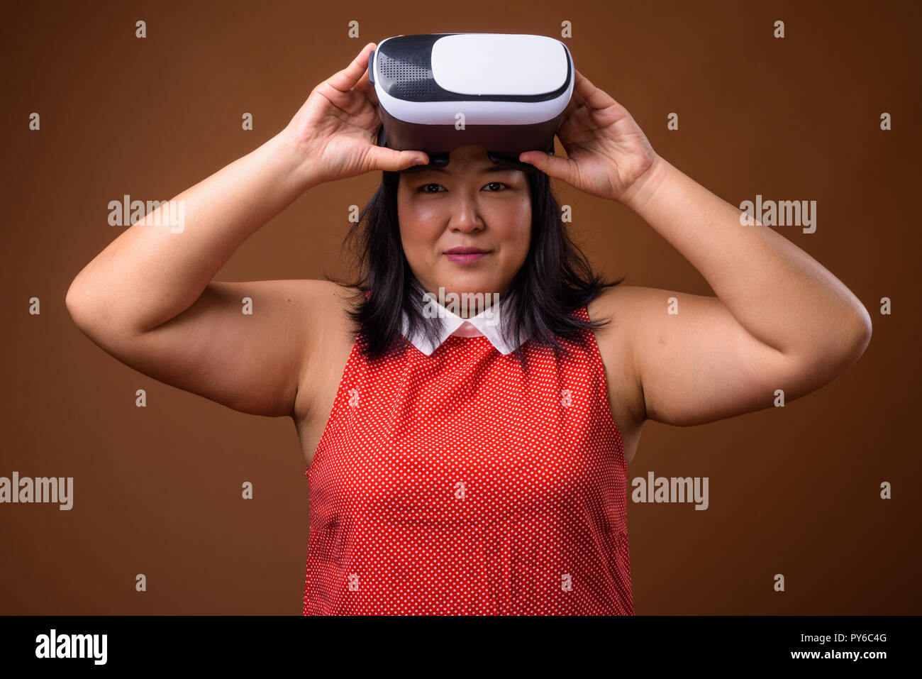 Portrait of Asian woman holding virtual reality VR glasses Stock Photo ...