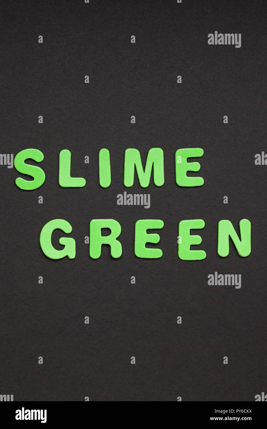 Creative colorful text made from plastic letters Slime green writing on ...