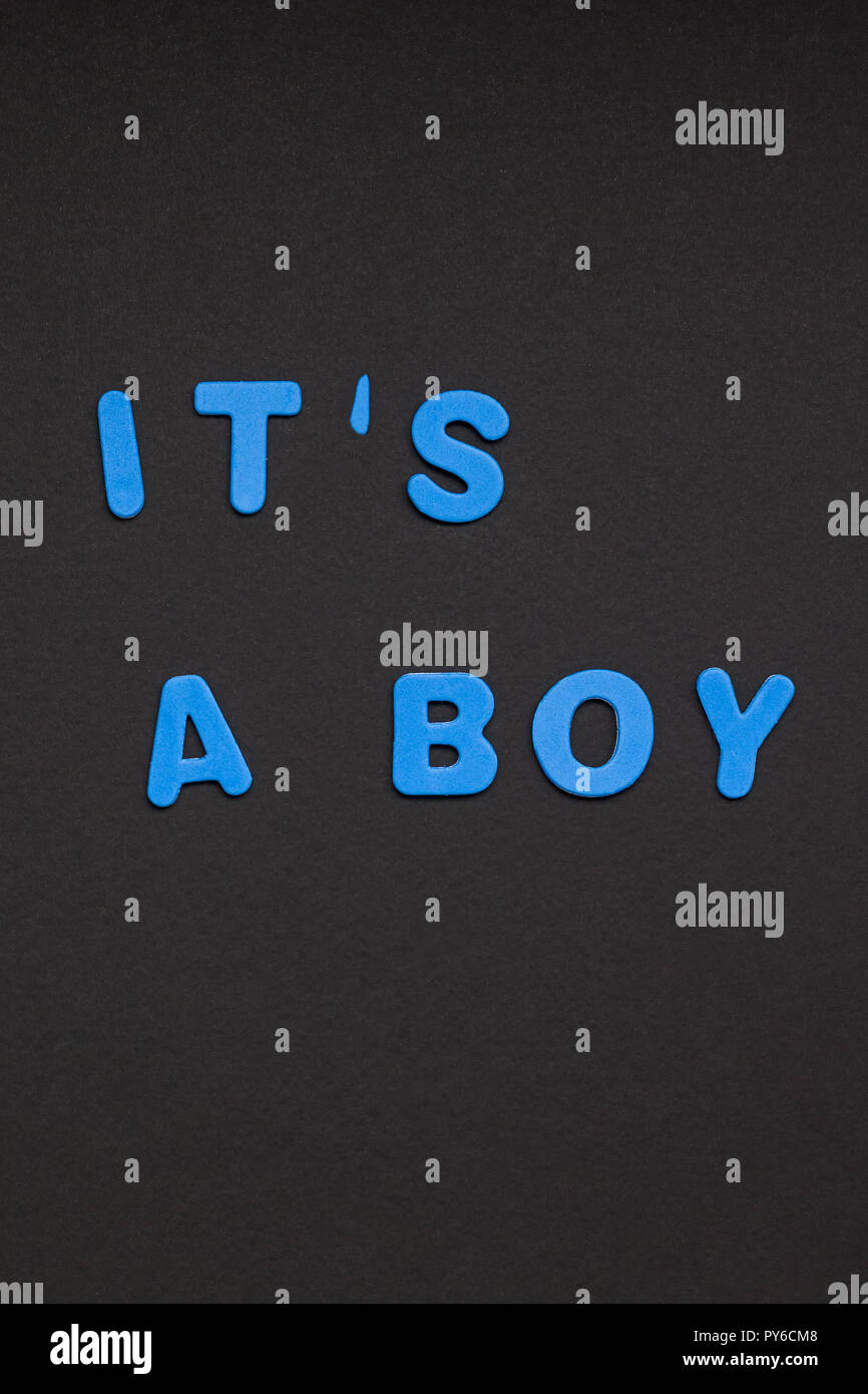 Creative blue text made from plastic letters It's a boy writing on ...